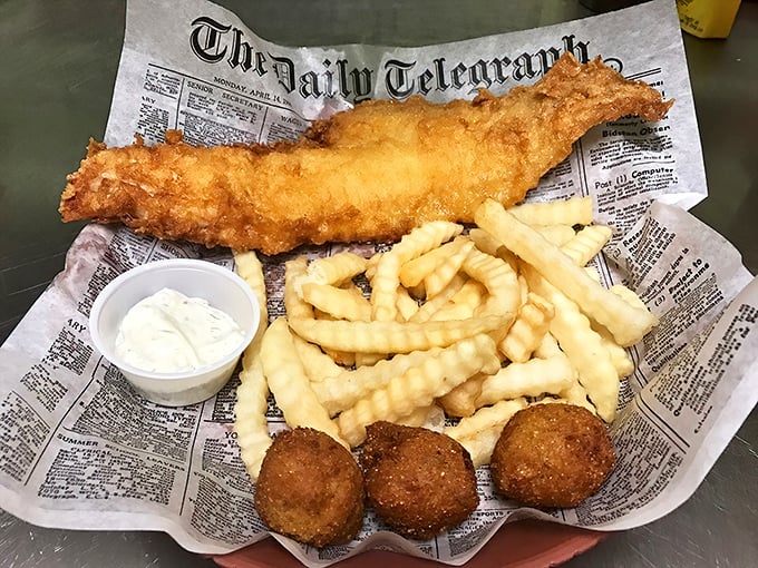 Fish and chips served on newspaper—a crispy, golden-battered tribute to simplicity that would make even British pubs nod in approval.