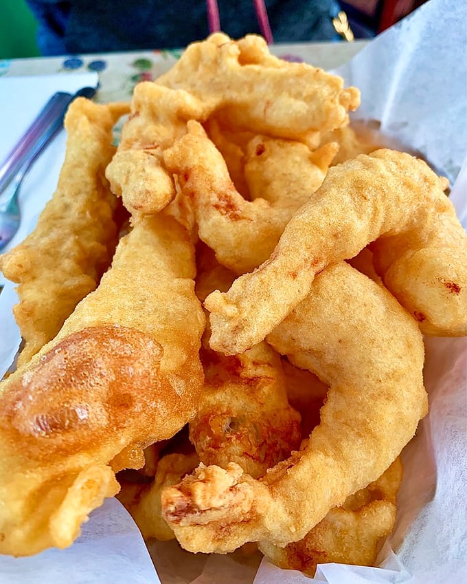 Batter so crisp you can practically hear it. These golden-fried treasures showcase the light, airy coating that transforms fresh seafood into crunchy delights.