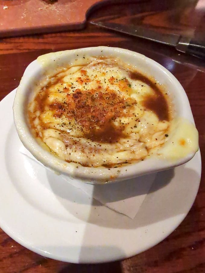 Behold the French onion soup—a bubbling cauldron of sweet onions and savory broth beneath a canopy of melted cheese that stretches with each spoonful.