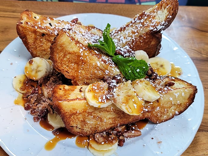 French toast that makes you question every other breakfast you've ever had—caramelized edges, fresh bananas, and enough maple syrup to make Canada jealous.
