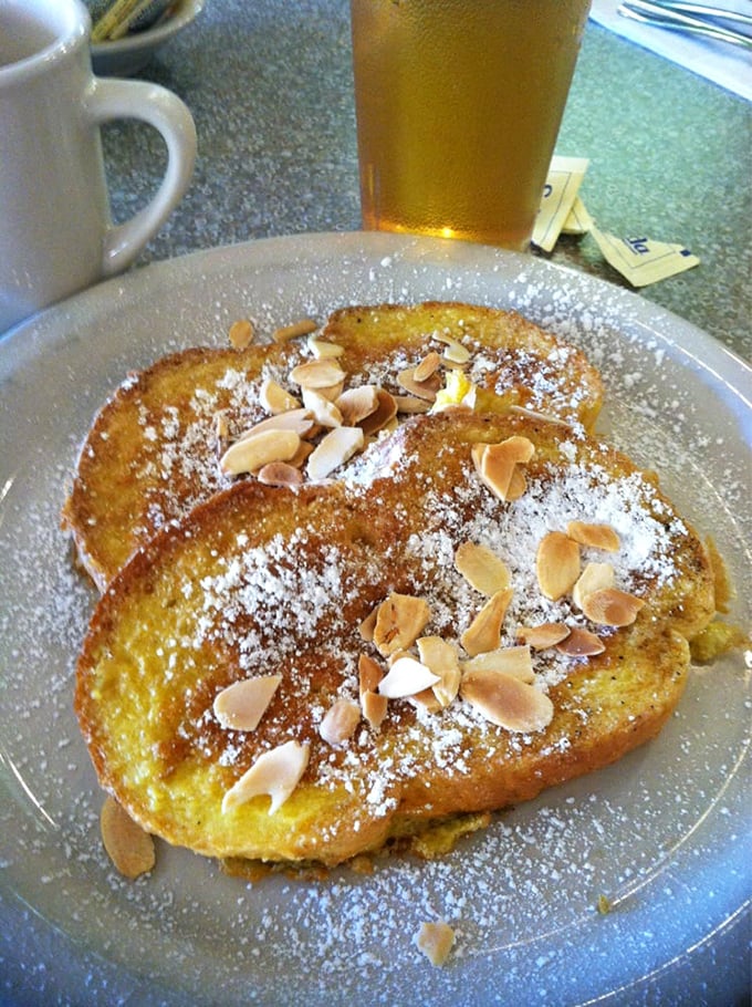 French toast that transcends ordinary breakfast fare. Those toasted almonds aren't just toppings—they're the crown jewels of morning indulgence.
