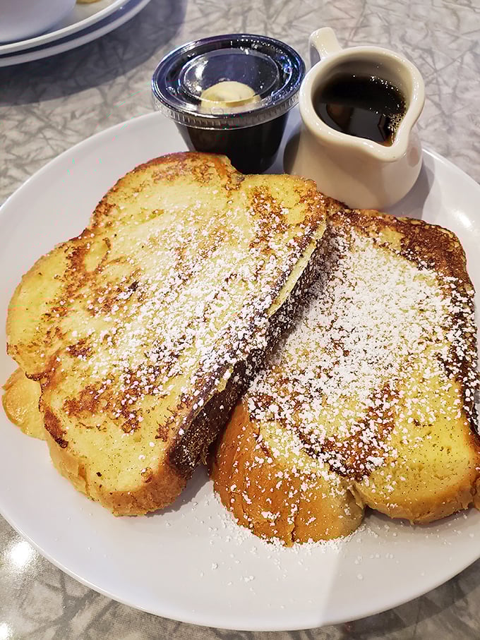 French toast that's dressed for success – powdered sugar dusting that's like fresh snow on a golden-brown landscape of deliciousness.