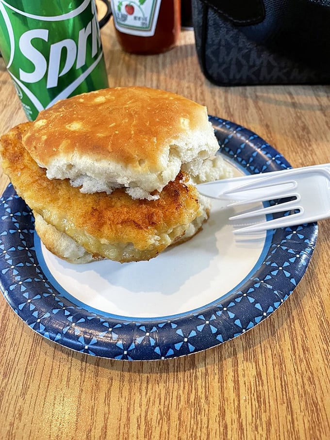 Breakfast sandwich nirvana achieved! A golden-brown biscuit embracing what appears to be a perfectly fried chicken cutlet—portable comfort at its finest.