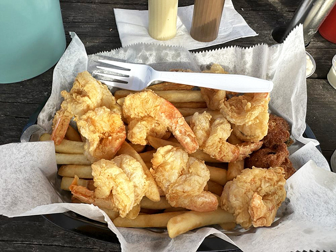 Golden-fried shrimp nestled on a bed of fries—proof that sometimes the simplest pleasures deliver the most profound satisfaction.