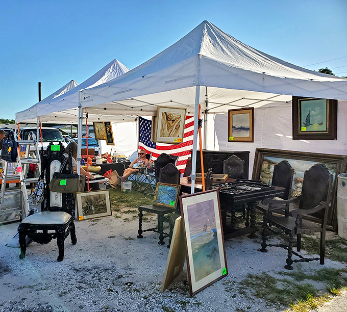 An impromptu art gallery under canvas where someone's discarded dining set becomes another's conversation piece.