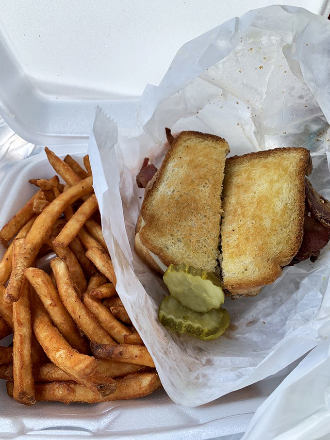 The grilled bacon hamburger sits proudly beside crinkle-cut fries – a duo that's been making Americans happy since before TikTok food trends were even a concept.