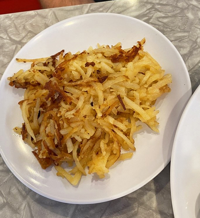 Hash browns that have achieved the breakfast trifecta: shredded just right, crispy edges, tender centers. The supporting actor that steals every breakfast scene.