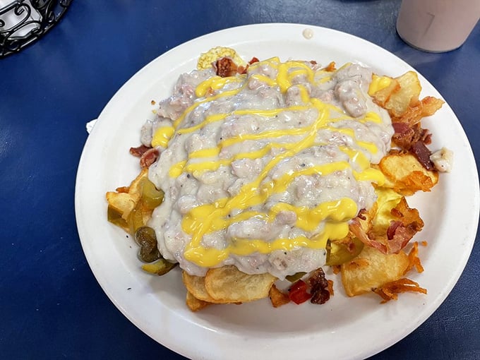 Behold the legendary "Haystack"—where home fries, sausage gravy, and cheese collide in a beautiful mess that somehow makes perfect sense at 9 AM.