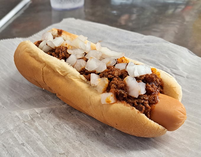 This isn't just a chili dog—it's a masterclass in the art of comfort food, where diced onions add the perfect crunch to that legendary spiced meat sauce.