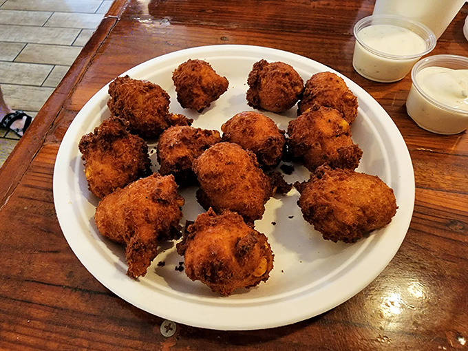 These hush puppies aren't staying quiet about their perfect crunch-to-softness ratio—they're practically shouting for a dunk in that sauce.