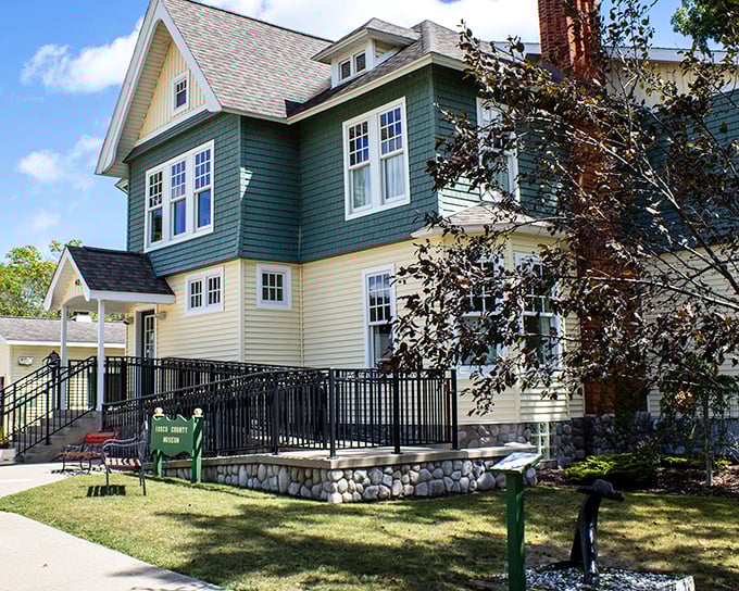 This stately green and yellow home preserves East Tawas history with architectural grace. Some buildings just know how to age beautifully.