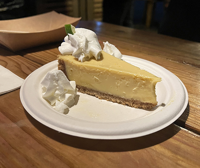 Key lime pie done right—tart, sweet, creamy, and topped with dollops of whipped cream that make you contemplate ordering a second slice immediately.