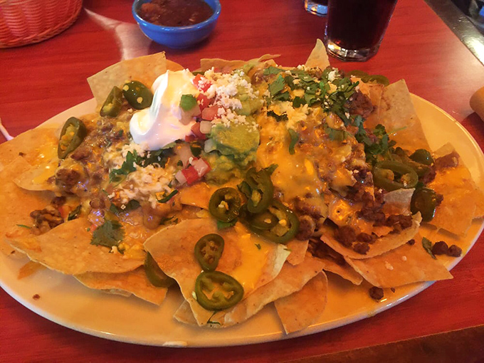 Layer upon glorious layer of chips, cheese, and toppings—like a geological formation that proves God wants us to be happy.