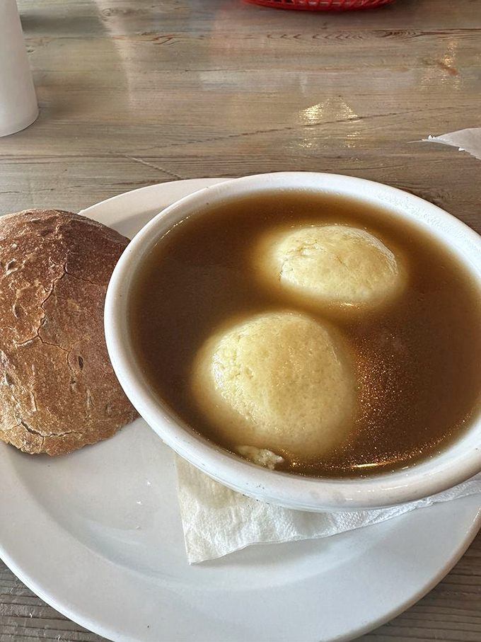 Matzo ball soup that would make your Jewish grandmother nod in approval – golden broth cradling fluffy dumplings that float like edible clouds.
