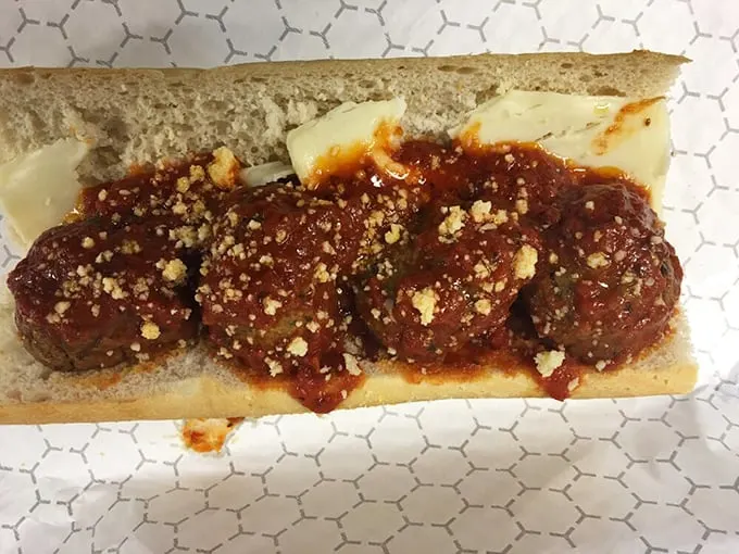 These meatballs aren't just swimming in sauce—they're doing the backstroke in a pool of red gravy worthy of Olympic gold.
