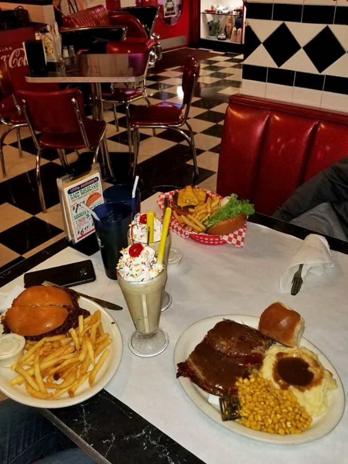 Green beans, mashed potatoes, and gravy-smothered meatloaf – the holy trinity of diner cuisine. Those rolls aren't just sitting there, they're calling your name.