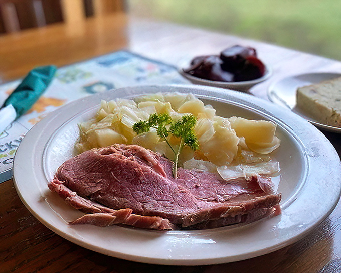 Behold the corned beef and cabbage—tender meat surrendering to the fork, alongside potatoes that have soaked up all the savory goodness.