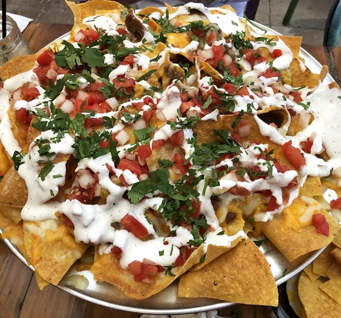 The nacho motherload has arrived! Golden chips supporting a perfect distribution of toppings—no sad, naked chips hiding at the bottom of this masterpiece.
