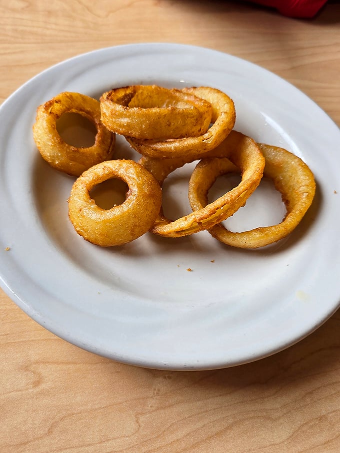 These onion rings aren't just fried—they're transformed. Golden halos of crispy perfection that make you wonder why anyone bothers with lesser versions.