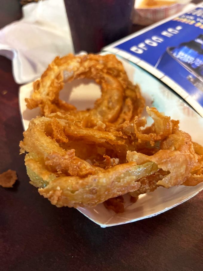 Onion rings that achieve the impossible: a shatteringly crisp exterior while maintaining that sweet, tender onion inside. Pure fried poetry.