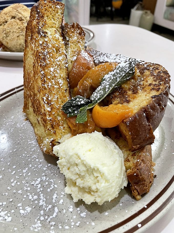 French toast that makes you question every other breakfast you've ever had. Caramelized peaches and powdered sugar transform bread into morning magic.