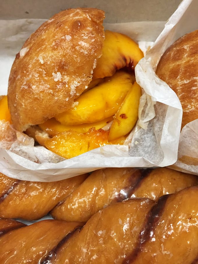 Summer's answer to the strawberry donut—fresh peaches nestled in pillowy dough create a seasonal masterpiece that inspires its own devoted following.