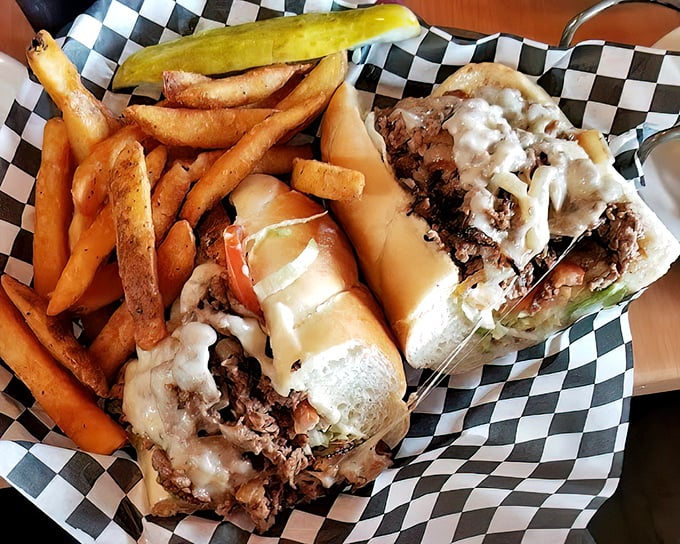 Behold the philly cheesesteak—served not on a traditional checkered paper but a proper basket that says, "Yes, this sandwich demands respect and proper cutlery."