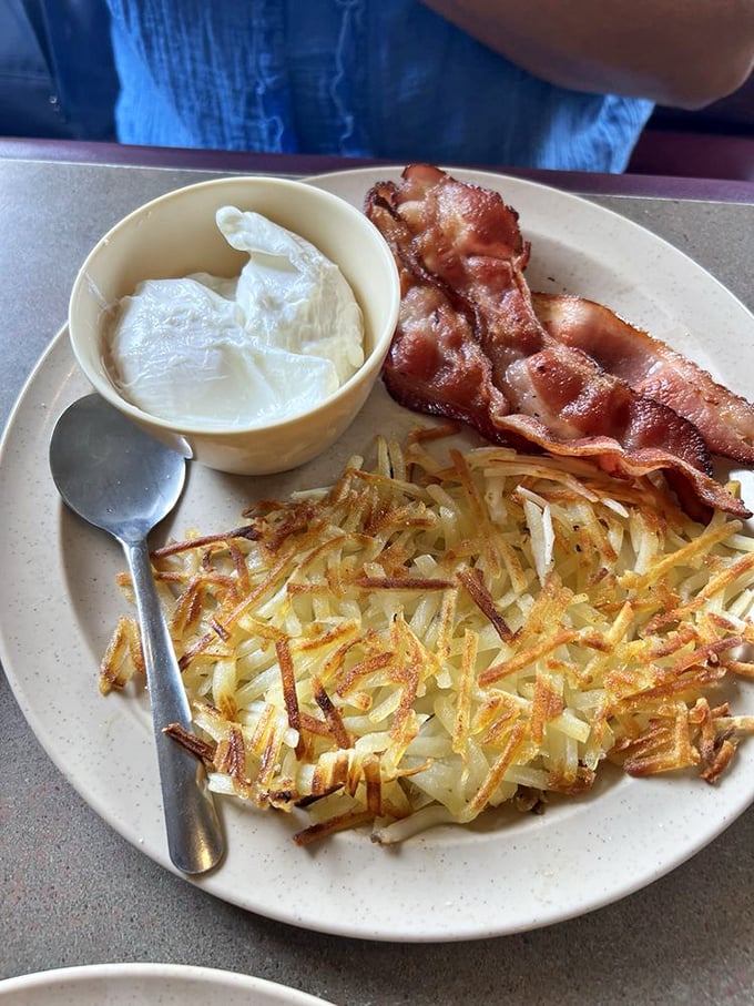 Hash browns that actually brown, bacon with the perfect crisp-to-chew ratio, and eggs that remind you why breakfast deserves its own category of joy.