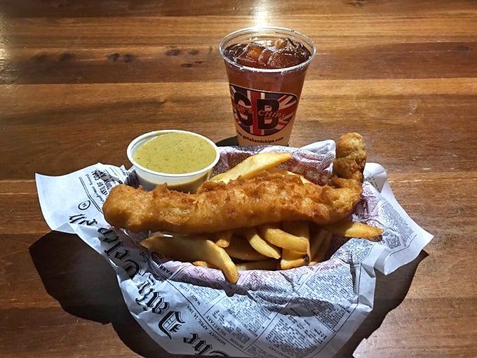 A golden-battered pollock fillet with chips and curry sauce—proof that sometimes the best vacation is the one you take with your taste buds.