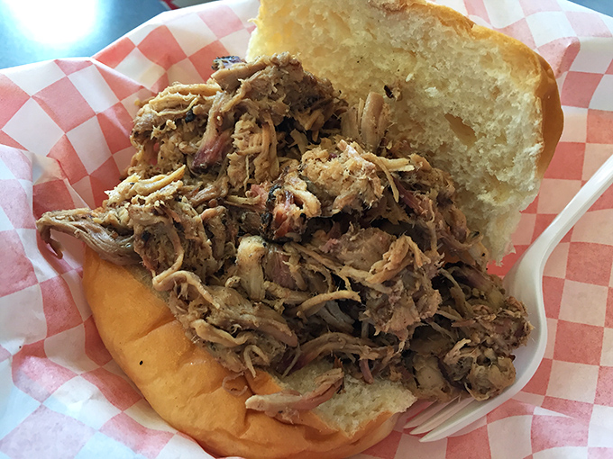 Pulled pork perfection on a bun—tender strands of smoky meat piled high, just waiting to transport you to barbecue nirvana.