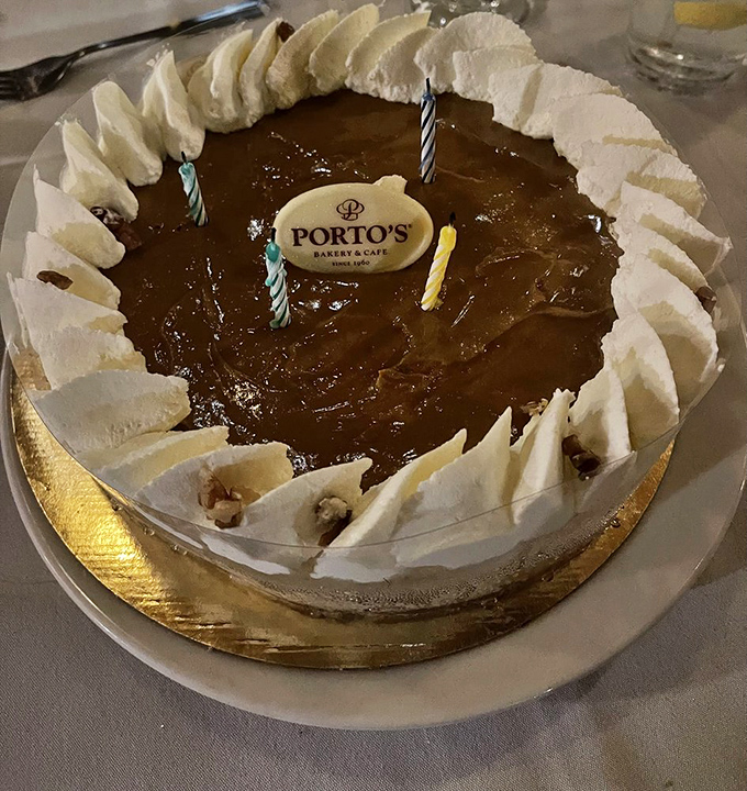 A celebration in cake form—Porto's pumpkin cheesecake with birthday candles proves that growing older deserves something creamier than wisdom.