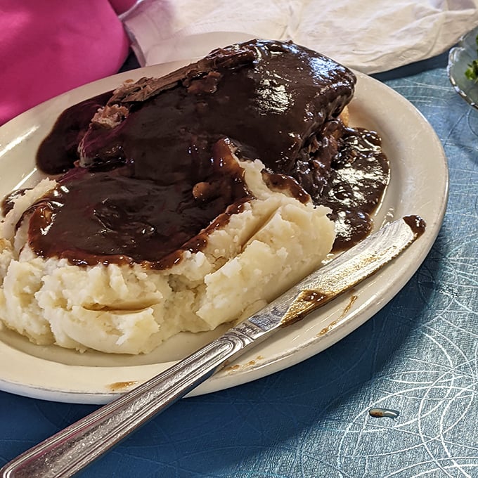 Meatloaf and mashed potatoes – the dynamic duo of diner cuisine. That gravy doesn't just cover the meat; it creates a savory lake that demands to be explored with each forkful.