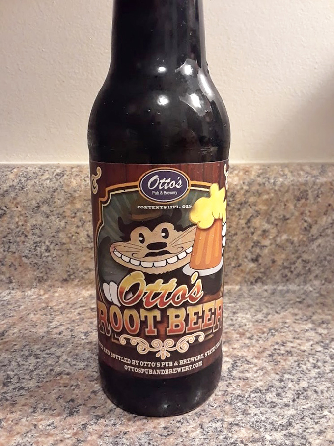Otto's Root Beer bottle grins at you like it knows something you don't—mainly how something so simple can taste so ridiculously satisfying.