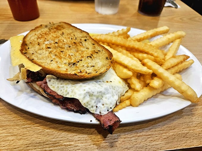 The Sasha sandwich brings together layers of flavor between perfectly grilled rye bread, with those golden fries standing at attention alongside.