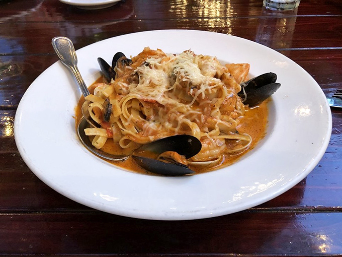 Seafood pasta that makes you question why you'd ever order anything else—tender noodles swimming with mussels in a sauce worth bottling and taking home.