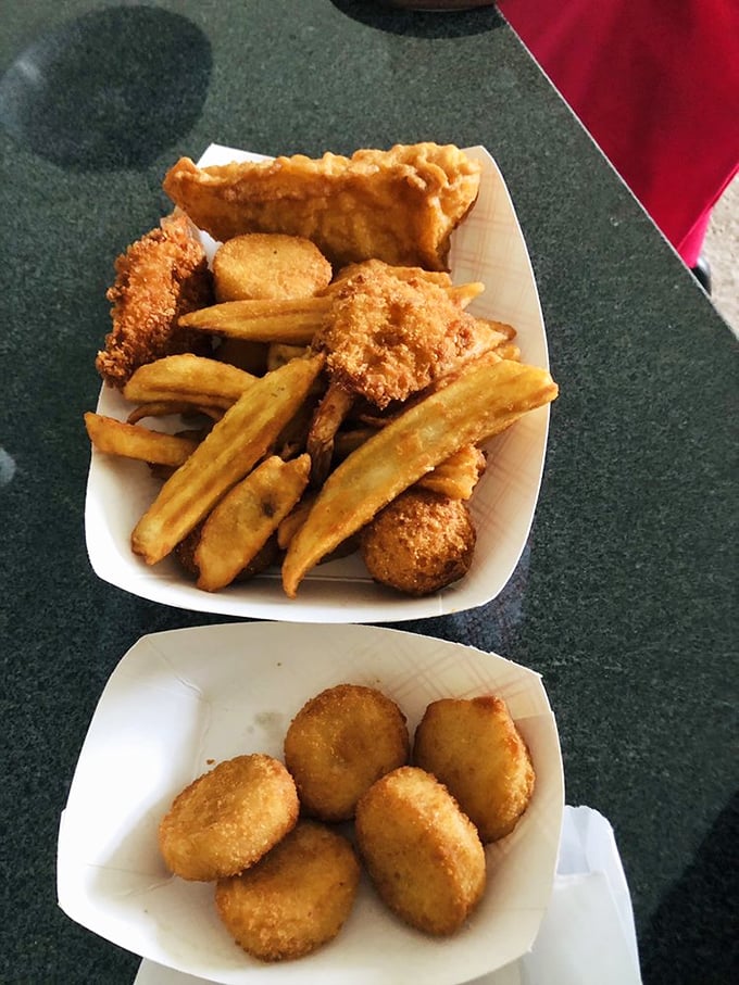 Hushpuppies and golden-fried seafood sharing a plate like old friends at a reunion. The kind of meal that makes you forget your table manners.