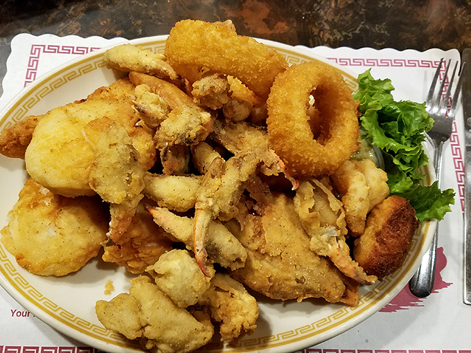 The seafood platter arrives like Neptune's personal feast—golden-fried treasures that make you wonder why anyone would eat seafood any other way.
