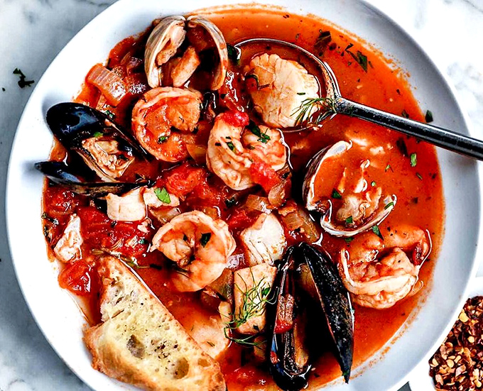 The cioppino arrives like a seafood block party where everyone's invited—shrimp, mussels, and fish all swimming in tomato broth glory.