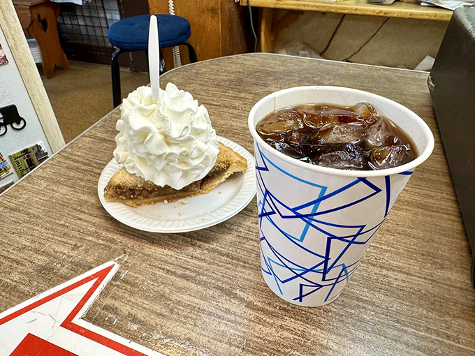 A mountain of whipped cream crowns a slice of shoofly pie, creating the Everest of desserts that's worth every sticky-fingered moment.