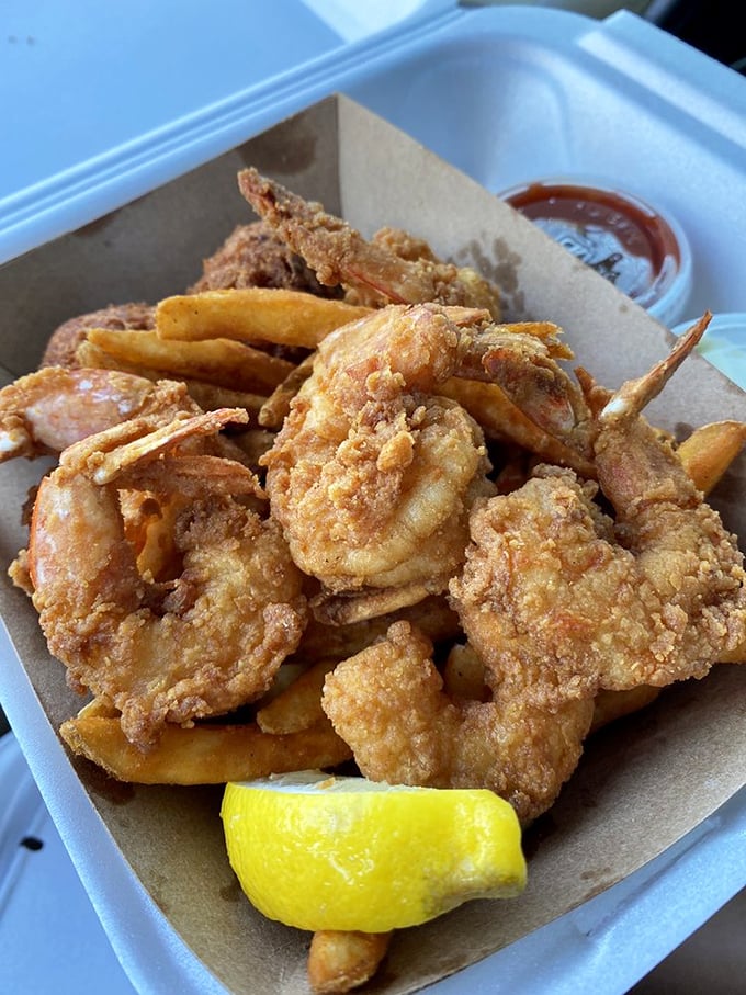 Golden-fried shrimp that snap between your teeth, paired with fries that could make a potato proud. The lemon wedge isn't decoration—it's essential equipment. 
