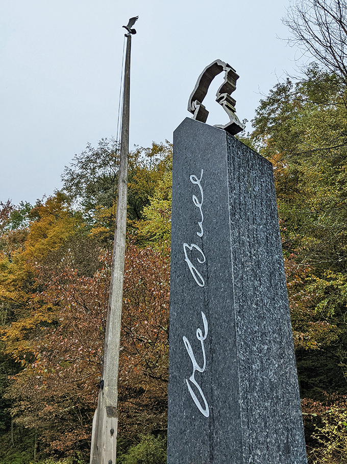 A monument to Ole Bull that stands tall among autumn foliage, proving that even failed utopias can leave beautiful legacies in unexpected places.
