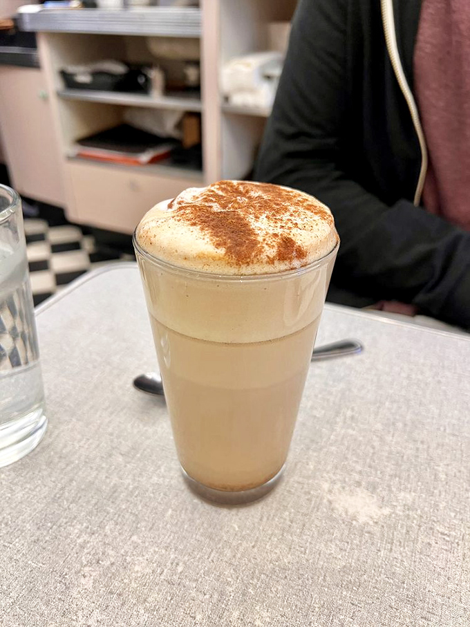 That's not just a latte—it's a warm hug in a glass, topped with cinnamon that makes your regular coffee order seem like a sad mistake.