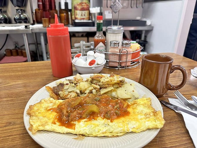 Breakfast alchemy at its finest: an omelet bathed in homestyle salsa with crispy potatoes standing by. Morning salvation for under $15.