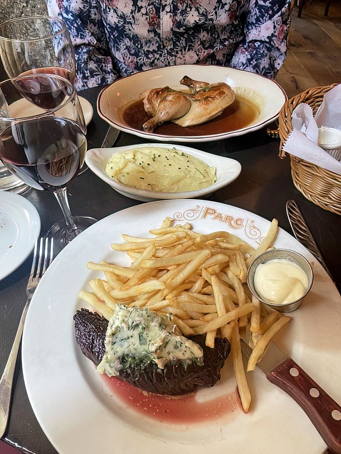 Two plates of steak frites and a glass of red wine—the holy trinity of French bistro dining. That jus is practically drinkable.