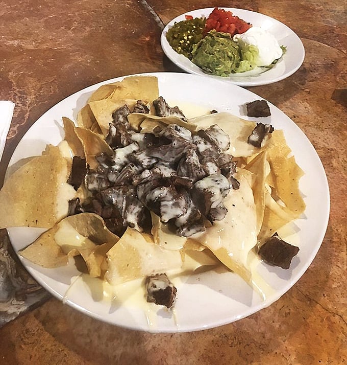 Steak nachos with the works—a plate that answers the eternal question: "Can happiness be served with guacamole on the side?" (Spoiler: yes, it can.)