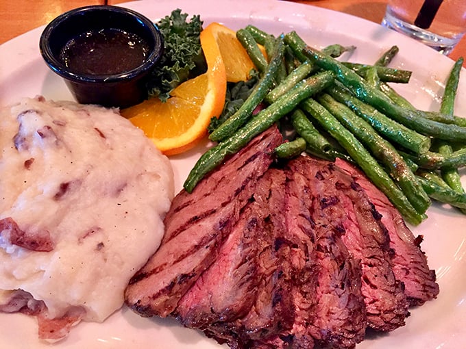 Steak sliced to reveal that perfect pink center, alongside green beans that actually deserve to share the plate. This isn't just dinner—it's edible artwork.