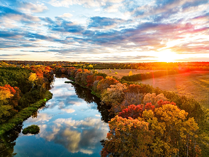 The Baraboo River reflects autumn's fiery palette, creating nature's version of an Instagram filter that actually improves on reality.