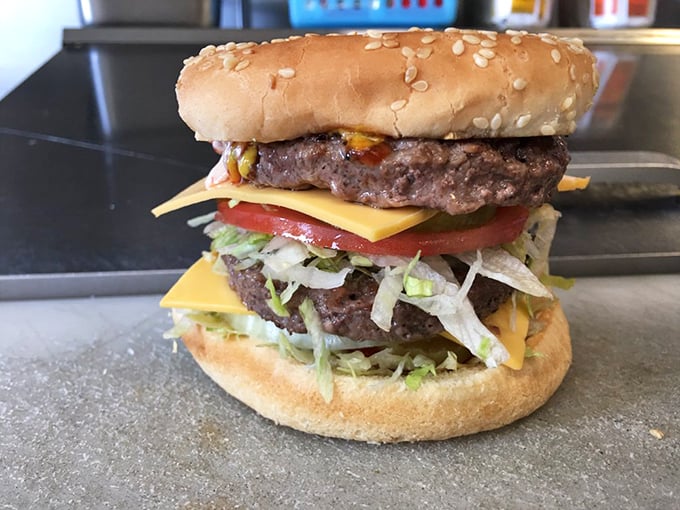 Behold the Super Cheeseburger in all its double-patty glory—architectural perfection that requires both hands and several napkins.