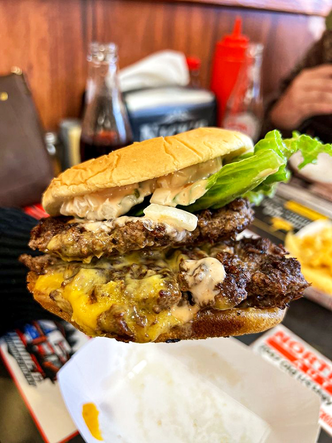 Behold the architectural marvel that is the double cheeseburger with all the fixings. Napkins aren't optional; they're a tactical necessity.