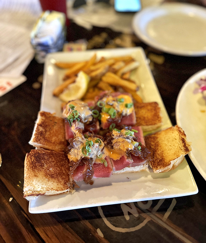 Tuna sliders that strike the perfect balance between sophisticated and fun—like wearing a tuxedo to a beach party, and somehow pulling it off.